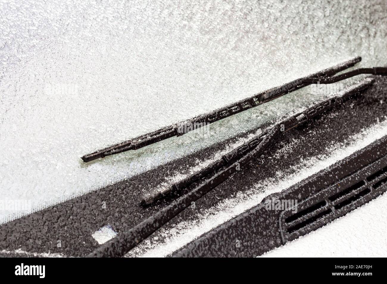 Frozen car wipers. Dangerous ice on the road. Frost on the windshield ...