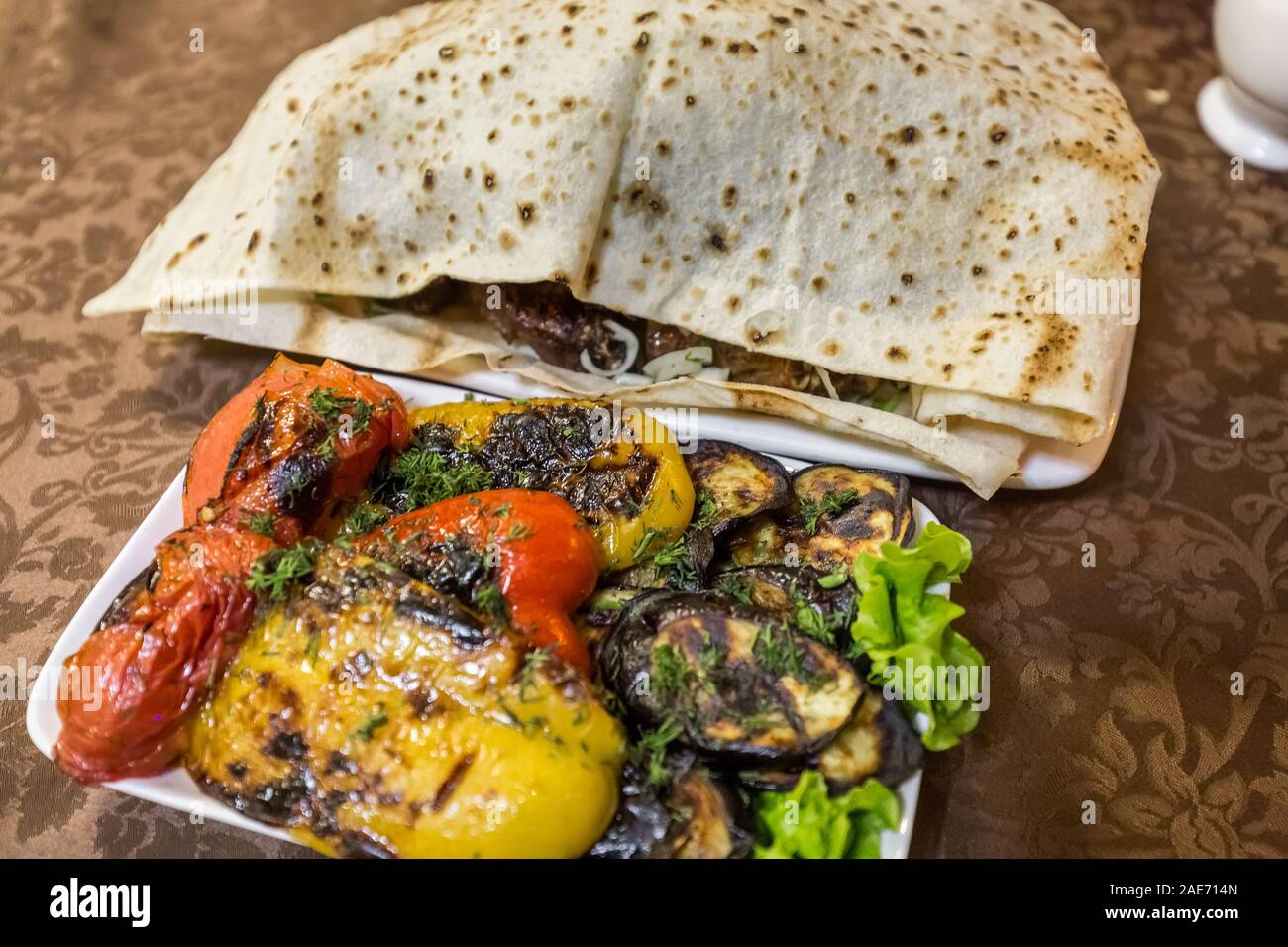 Traditional georgian food - shish kebab and grilled vegetables on a ...