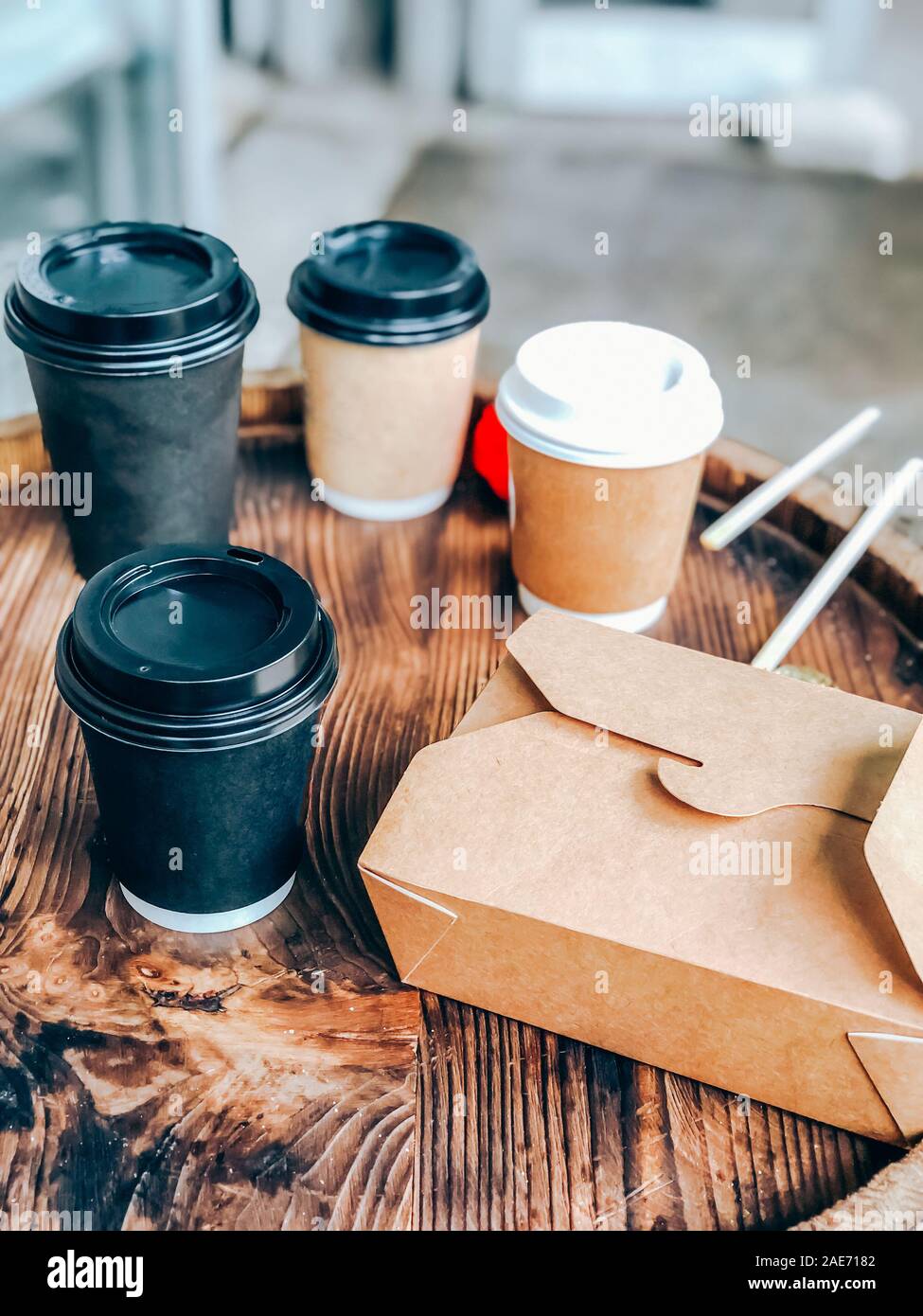 Coffee cups and street food craft paper container on a wooden outdoor ...