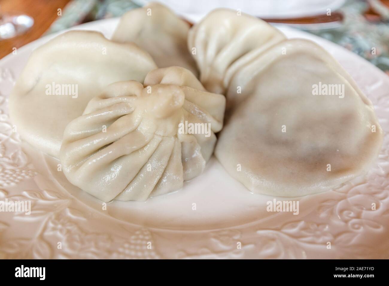 Georgian dumplings Khinkali with meat, greens and tomato spicy sauce on ...