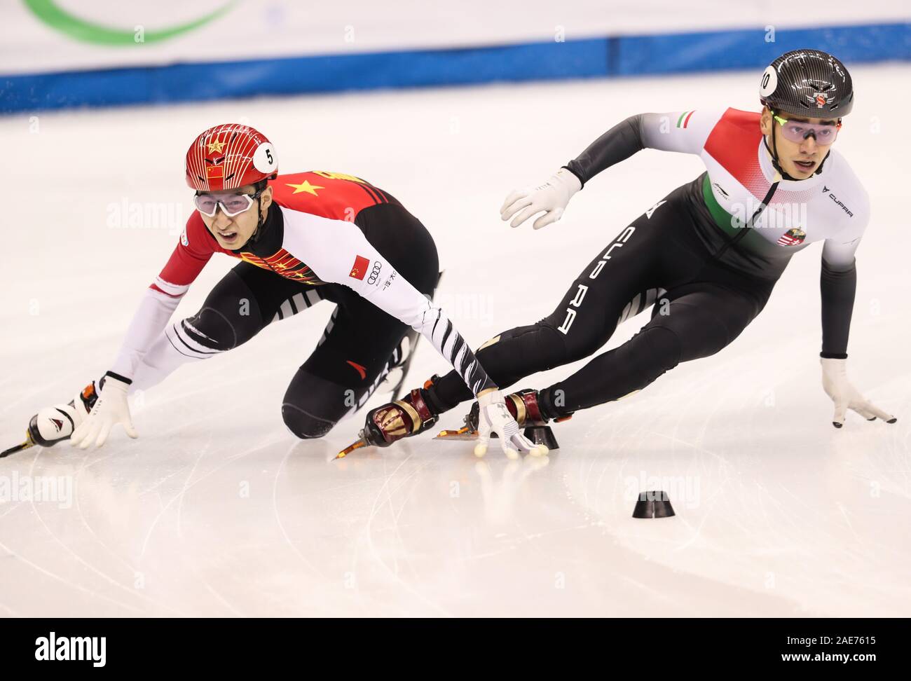 Shanghai, China. 7th Dec, 2019. Wu Dajing (L) of China competes with ...