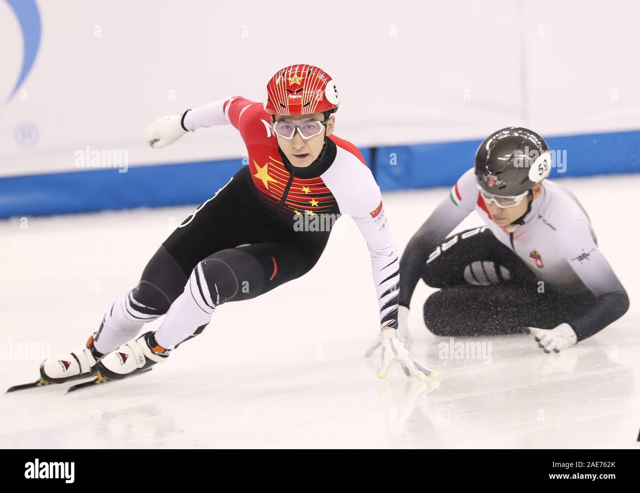 Shanghai, China. 7th Dec, 2019. Wu Dajing (L) of China competes with ...