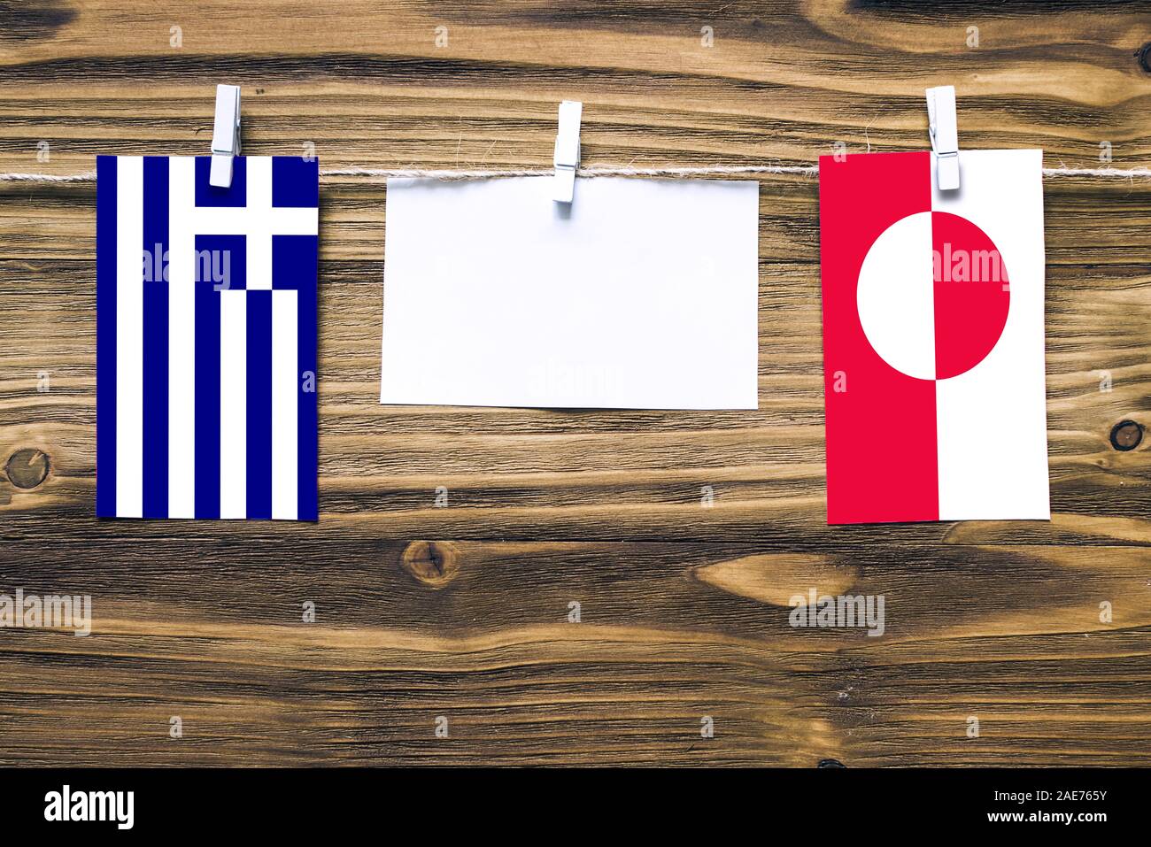 Hanging flags of Greece and Greenland attached to rope with clothes ...