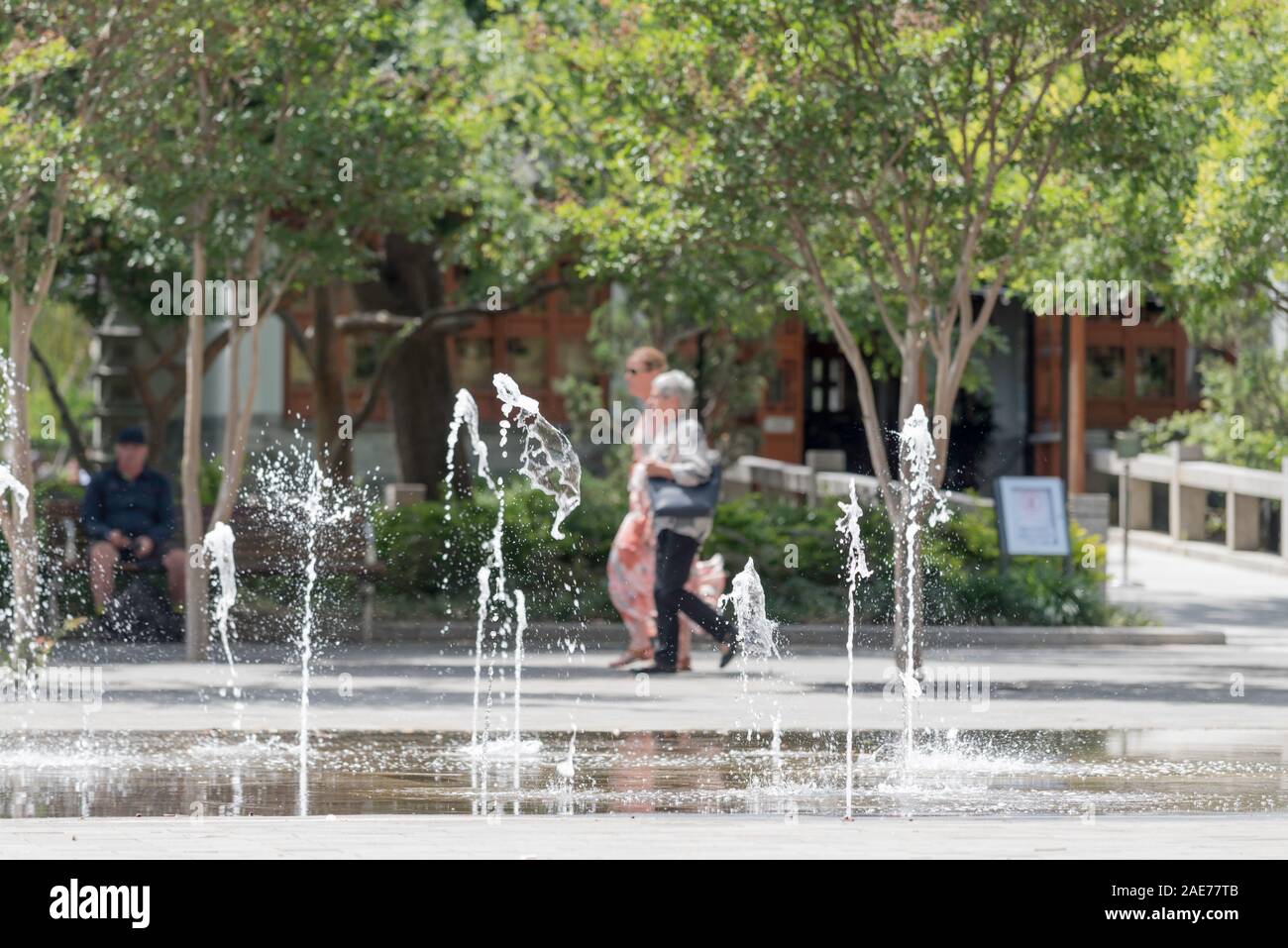 In-ground water fountains squirt water into the air in a playground ...