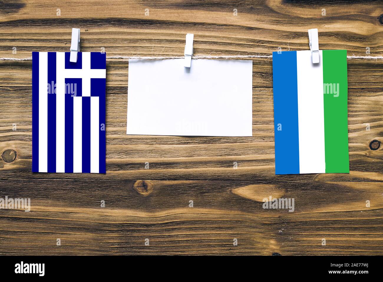 Hanging flags of Greece and Sierra Leone attached to rope with clothes ...
