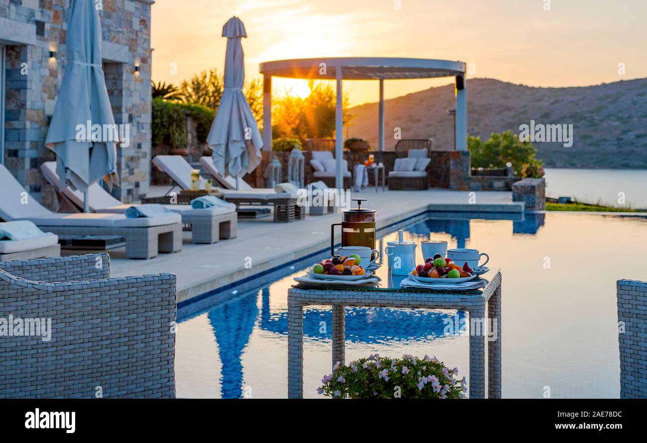 Serving table with fruits and coffee near the outdoor pool Stock Photo ...