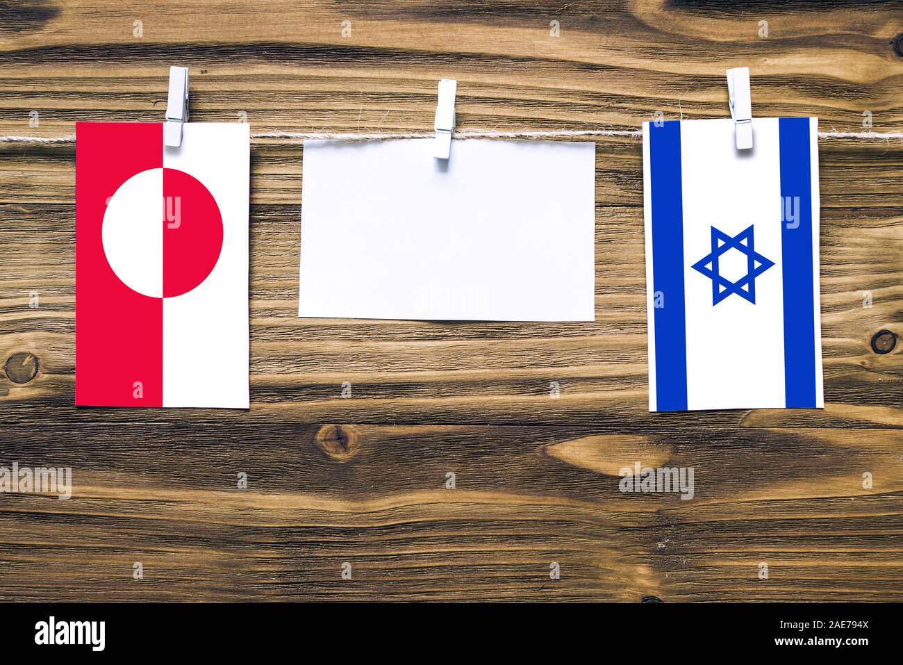 Hanging flags of Greenland and Israel attached to rope with clothes ...
