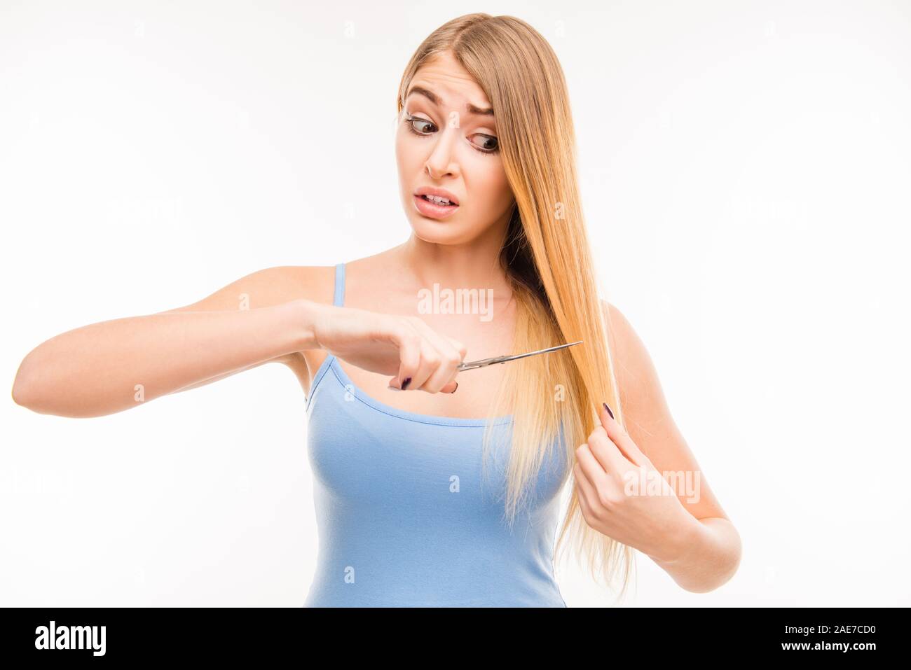 Pretty woman cutting her split ends Stock Photo - Alamy