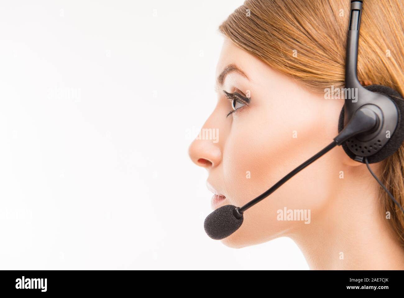 A close-up side-face portrait of a young agent of call centre Stock ...