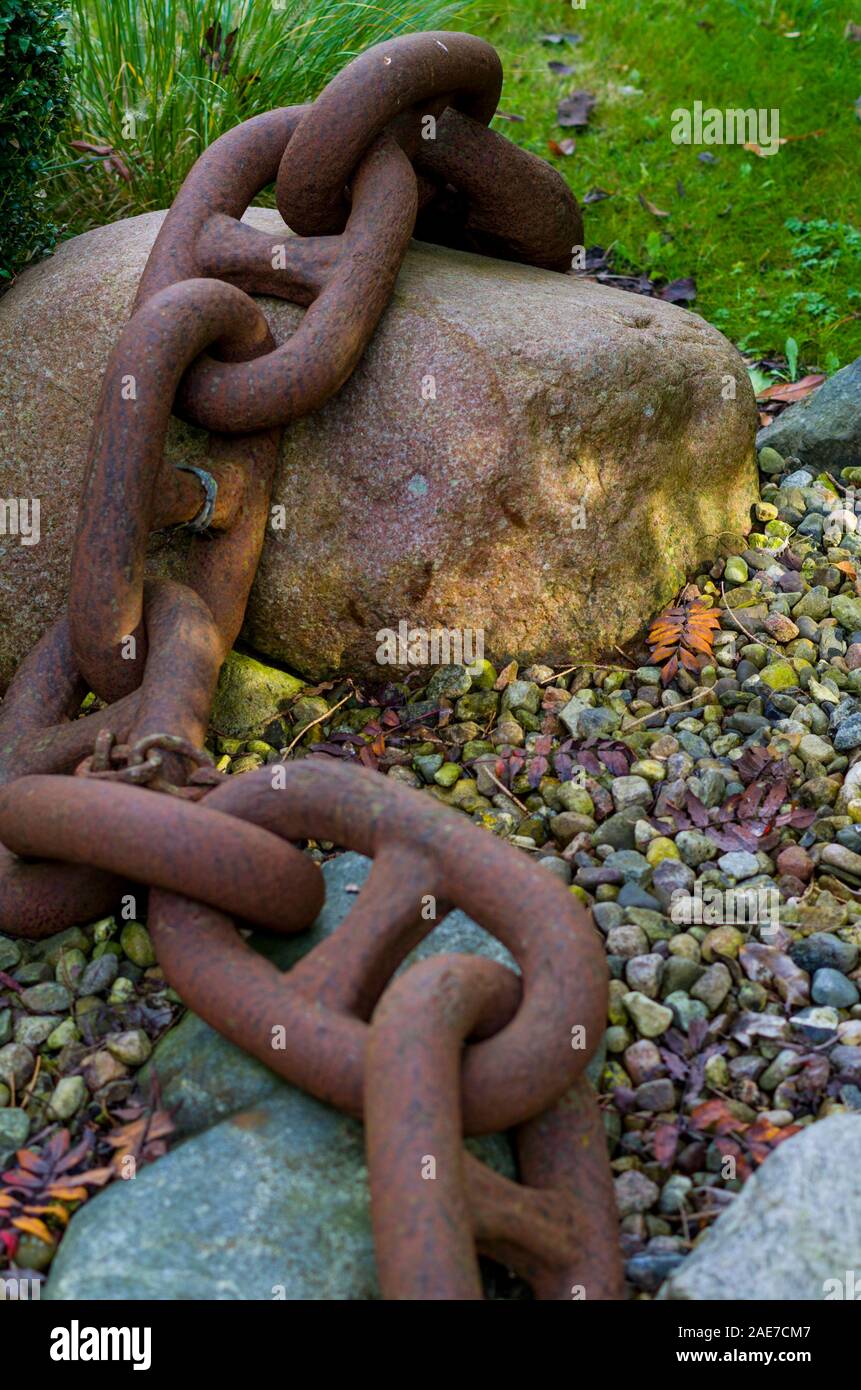 Ship rusty chain resting on stones. Symbol of strength, security and ...