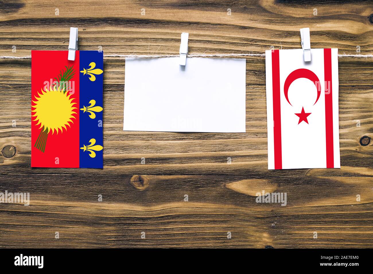 Hanging flags of Guadeloupe and Northern Cyprus attached to rope with ...