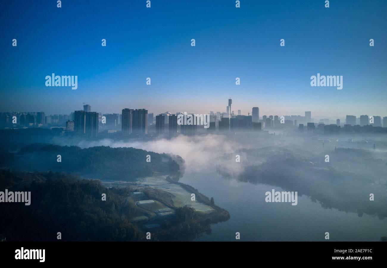Cityscape of Guiyang with buildings and houses shrouded by fog in ...