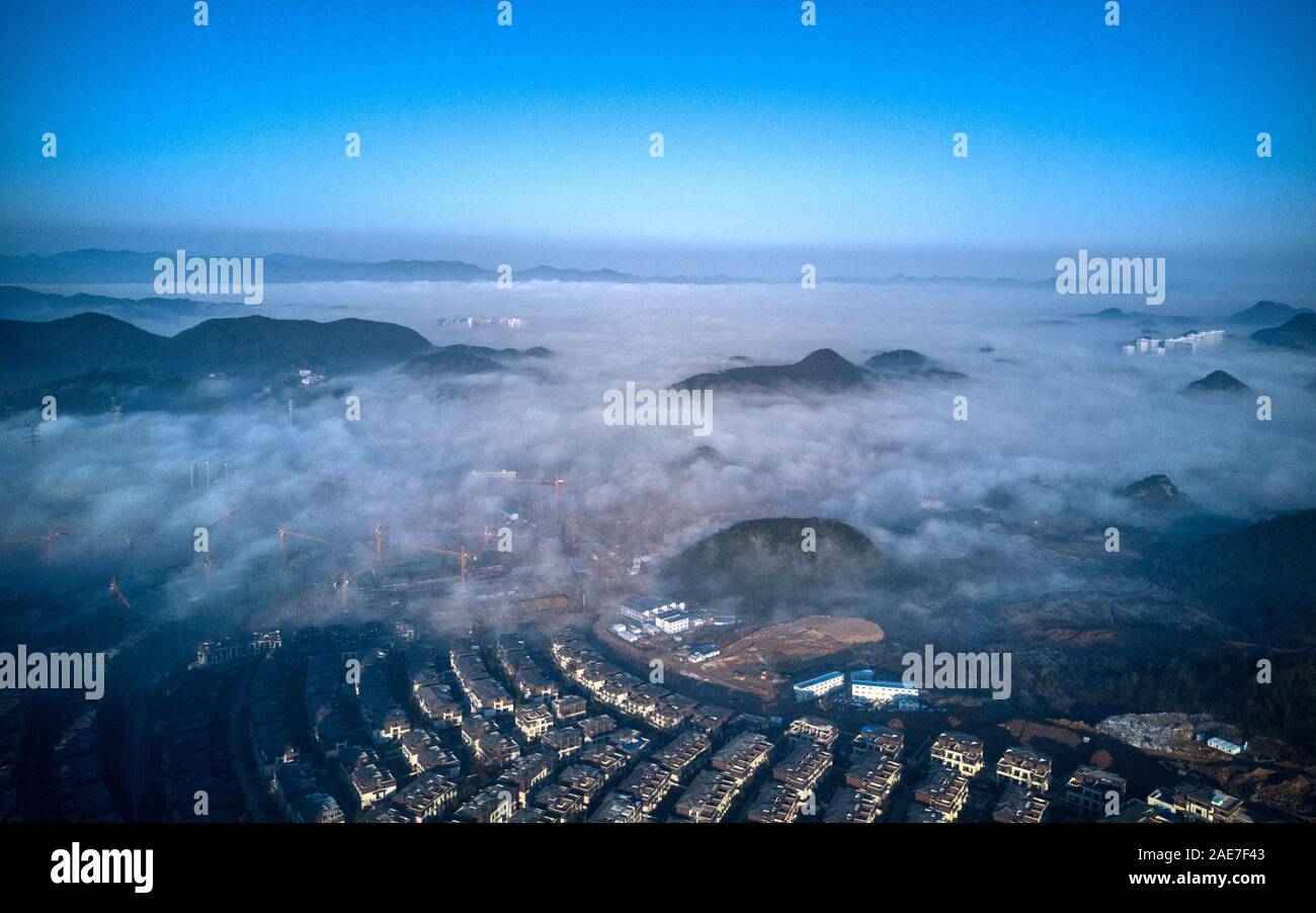 Cityscape of Guiyang with buildings and houses shrouded by fog in ...
