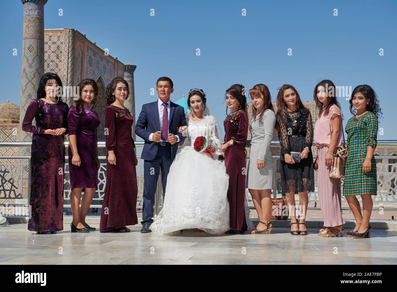 wedding party posing in front of famous Registan Square, Samarkand ...