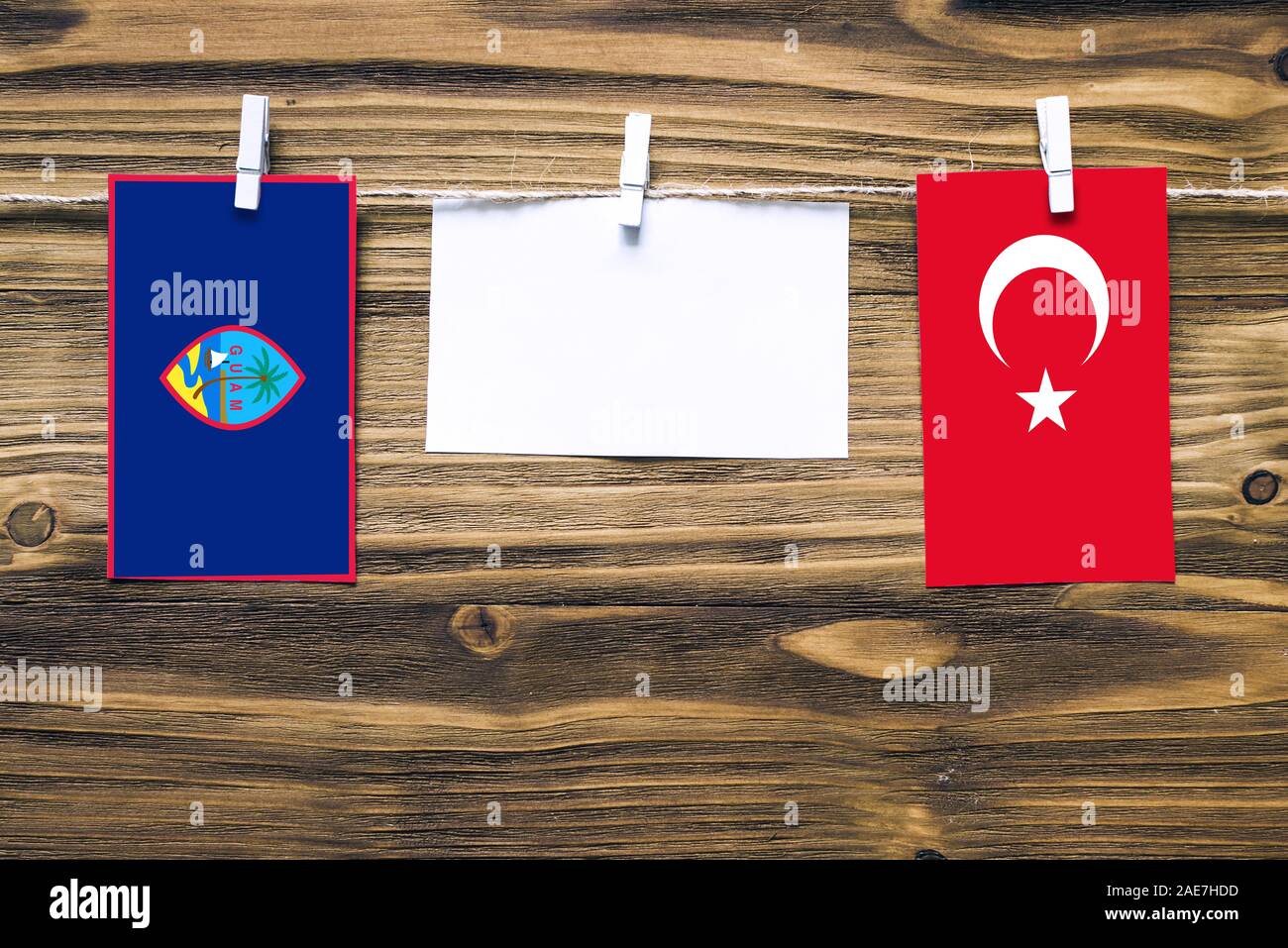 Hanging flags of Guam and Turkey attached to rope with clothes pins ...