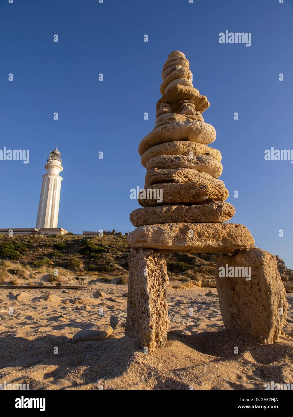 Stack of stones in balance on the beach of Trafalgar Lighthouse. Cádiz ...