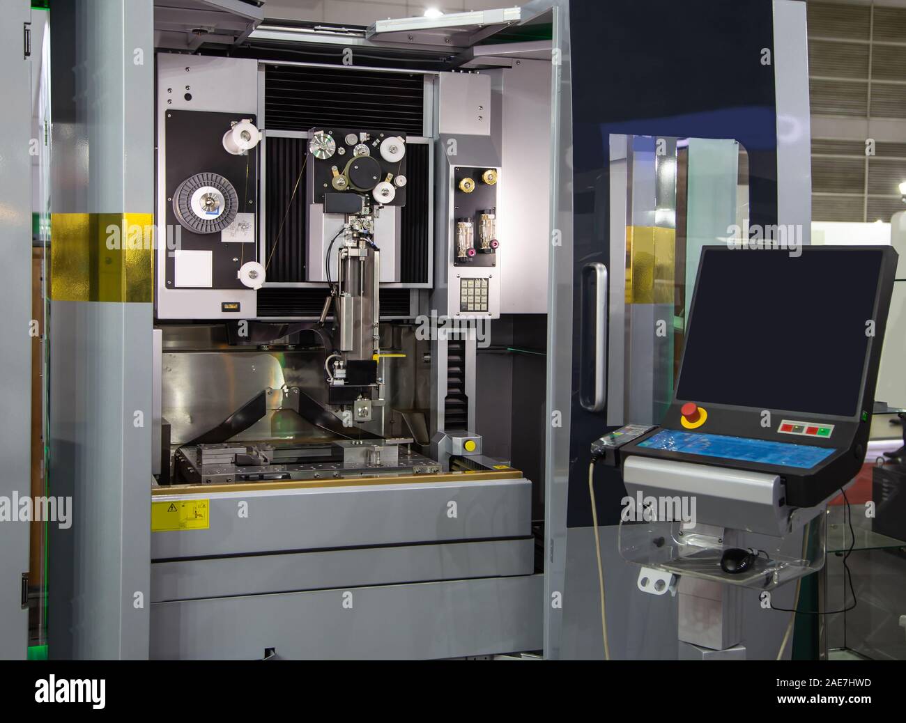 Electrical discharge machine EDM cutting workpiece in workshop Stock ...