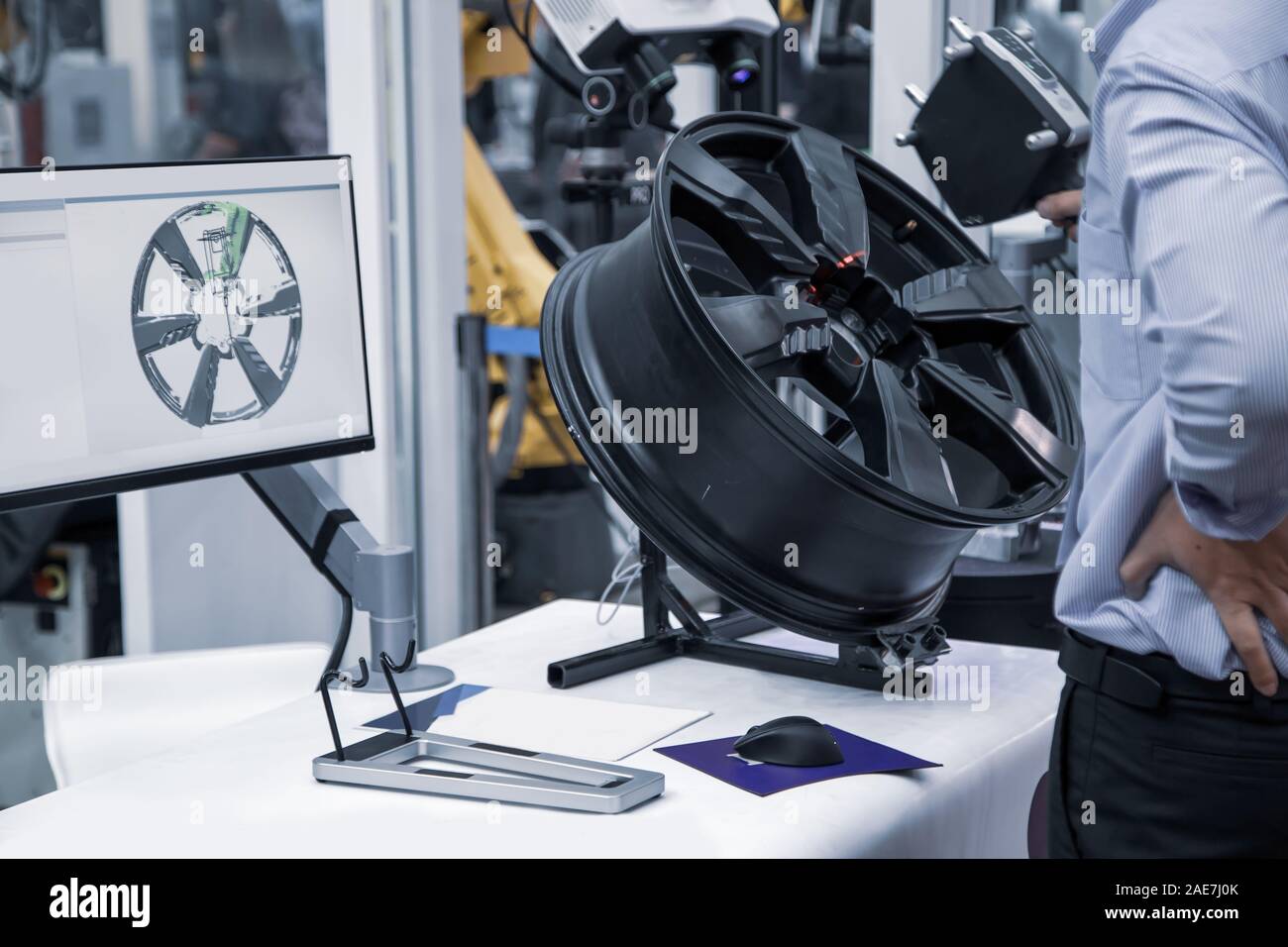 Industry worker use handheld 3D scanner inspecting a wheel Stock Photo ...