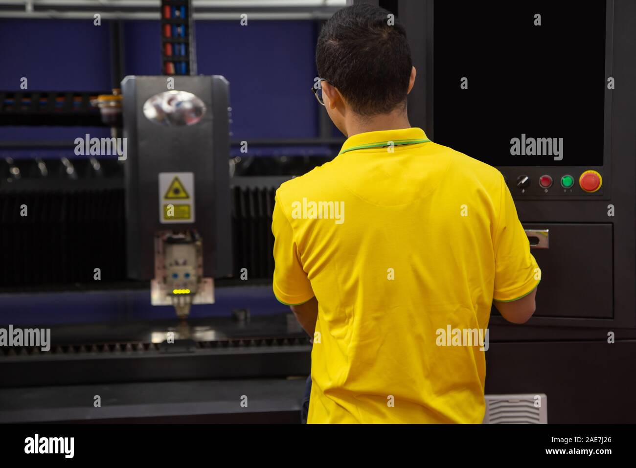 Industrial worker operate CNC fiber laser cutting machine Stock Photo ...