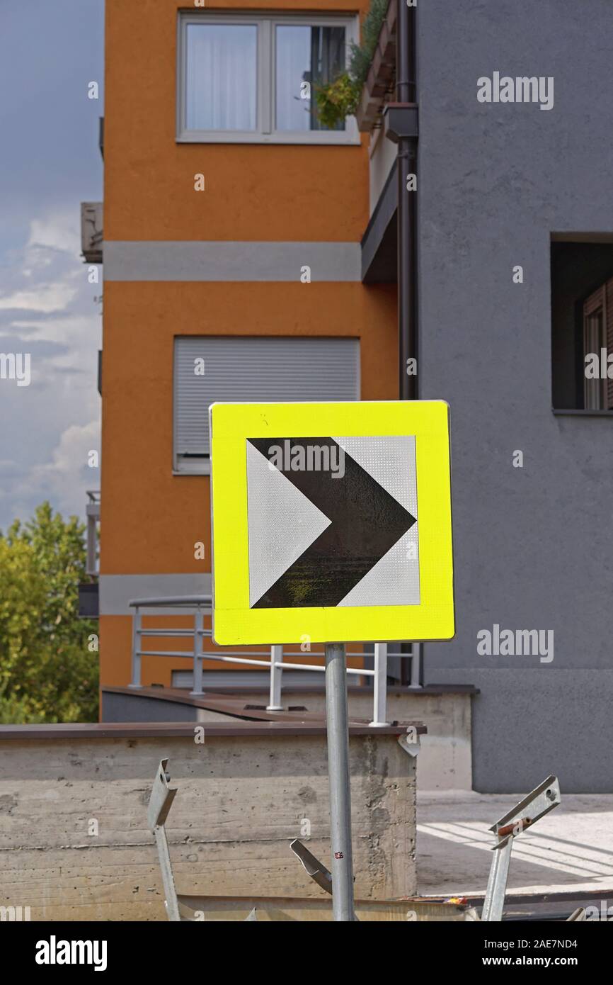 Chevron right arrow warning traffic sign in town Stock Photo - Alamy