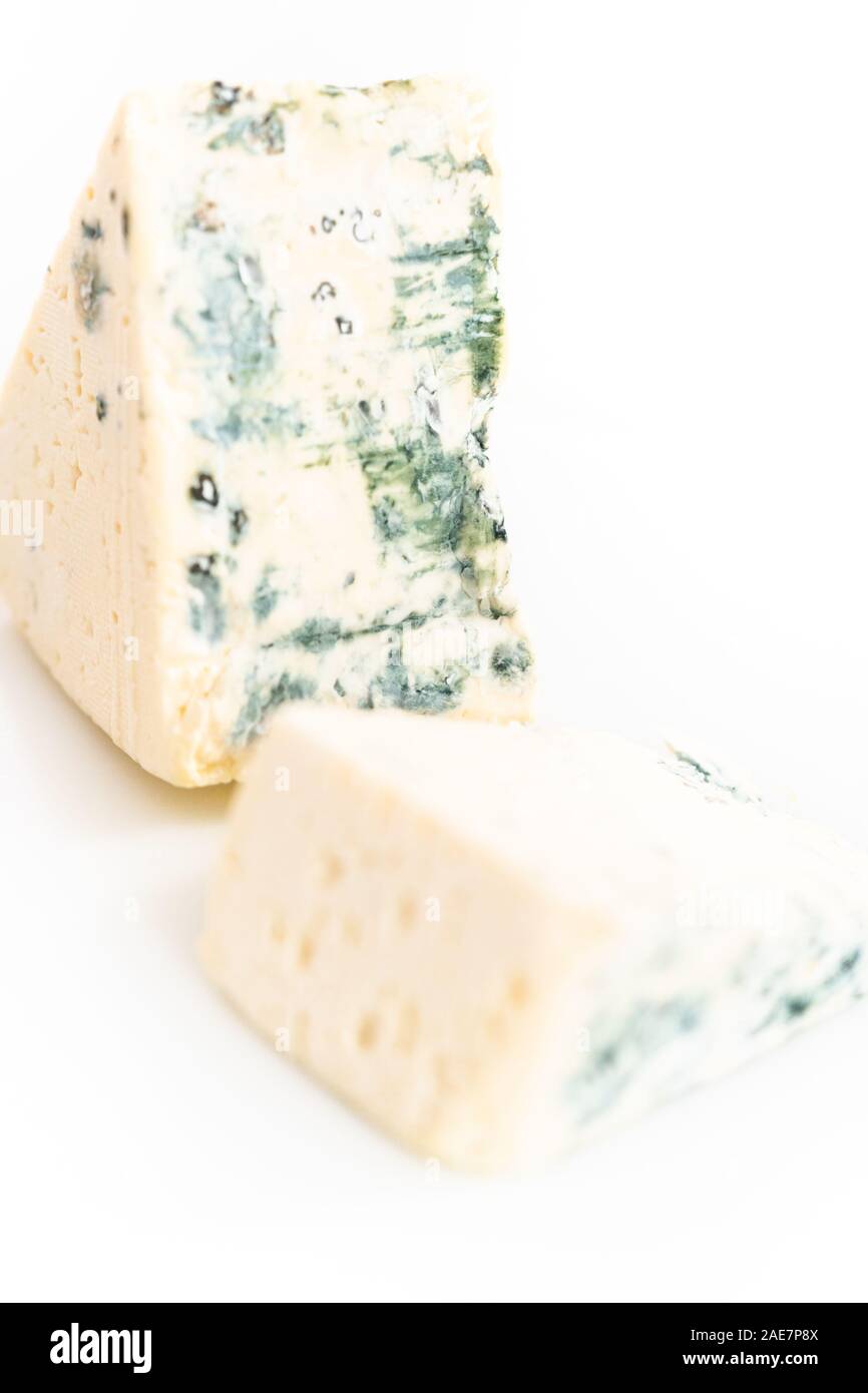 Large slice of blue cheese on a white background Stock Photo - Alamy