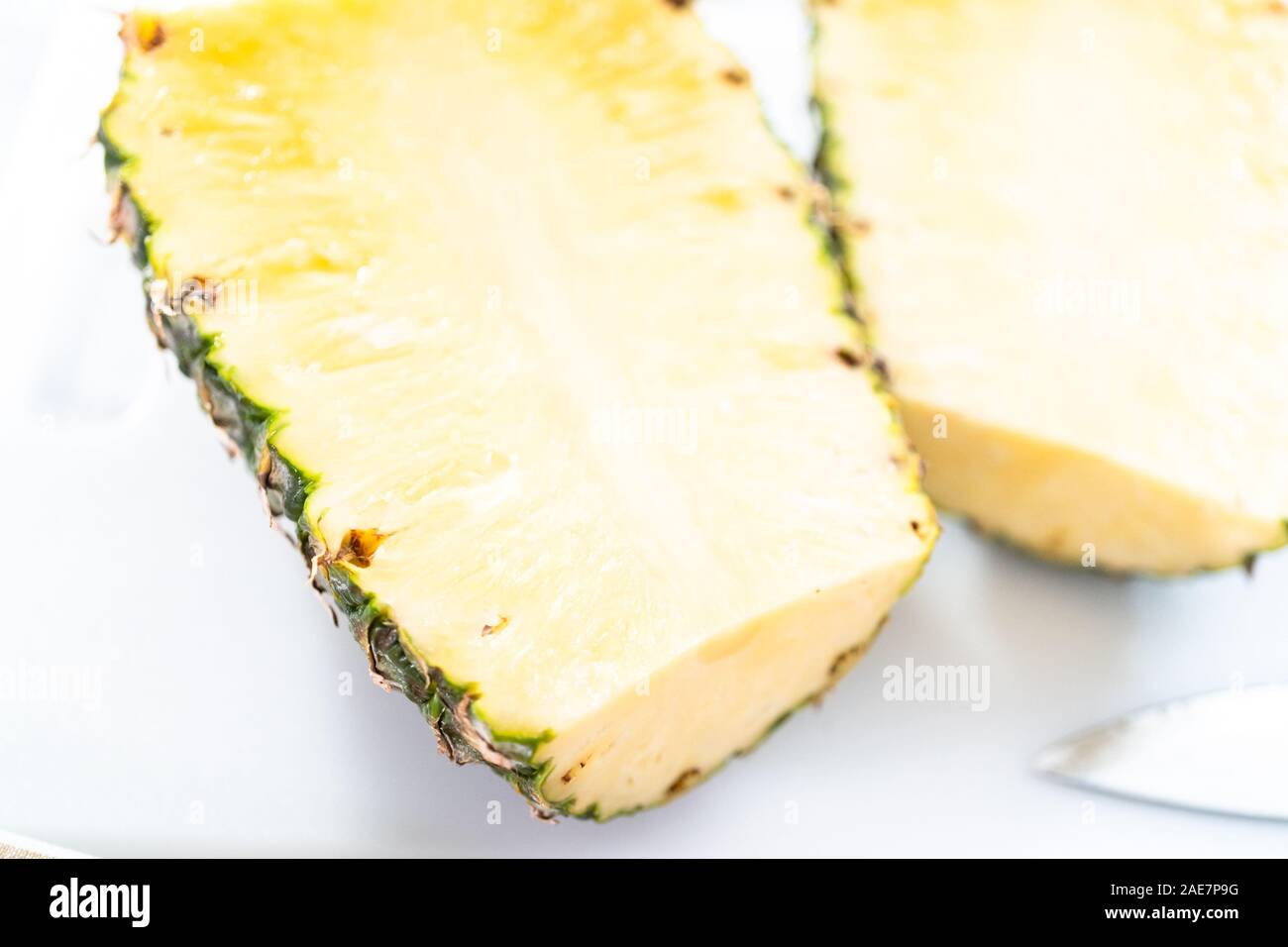 Cleaning and cutting a pineapple into the small pieces Stock Photo - Alamy