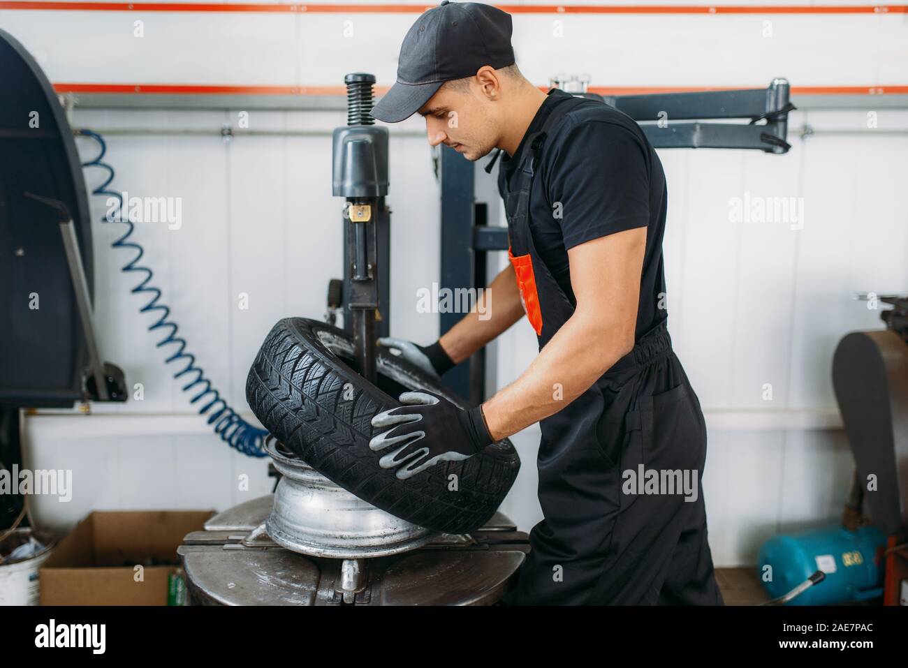 Mechanic change tire, repairing service Stock Photo - Alamy