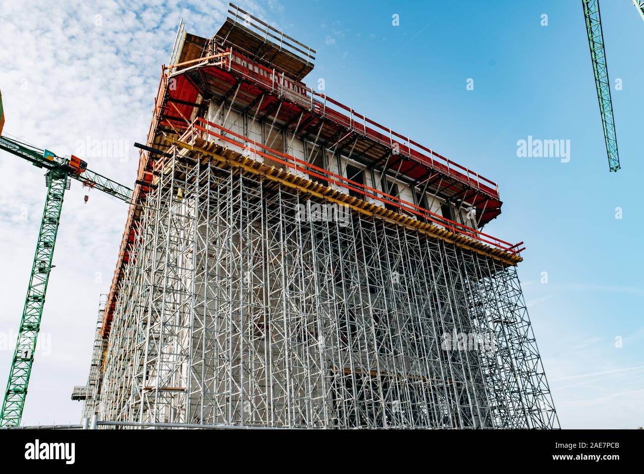 Construction of multi-storey building with cranes Stock Photo - Alamy