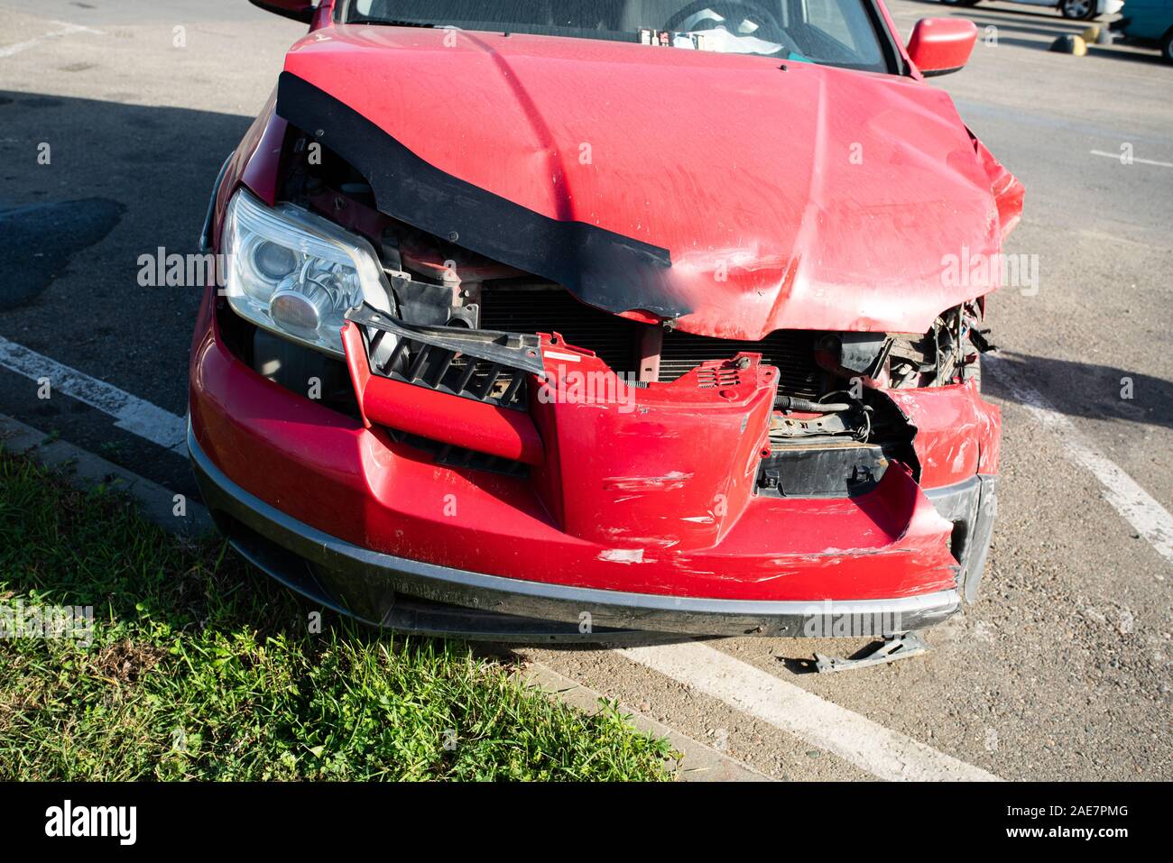 Front of red car get damaged by accident on the road Stock Photo - Alamy