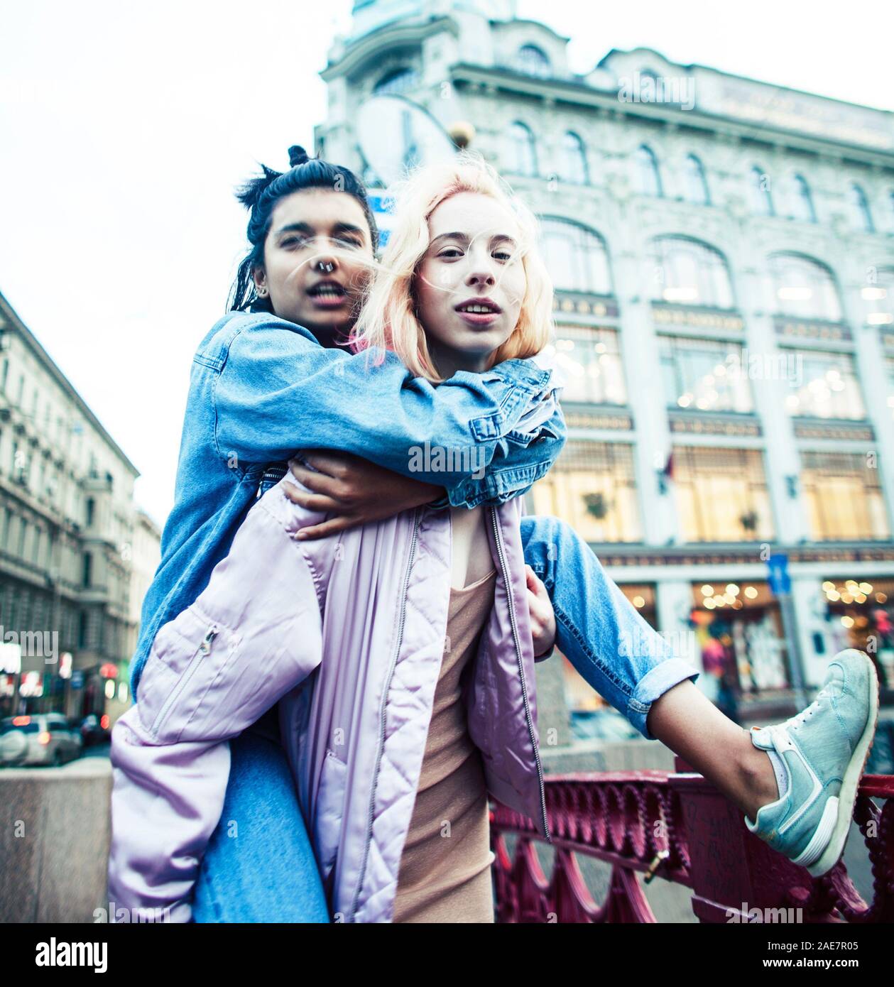 Two teenage girls infront of university building smiling, having fun ...