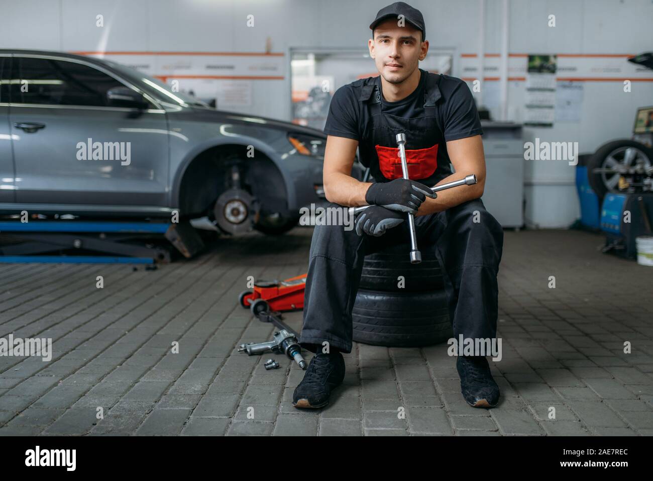 Mechanic repairing vehicle sitting hi-res stock photography and images ...