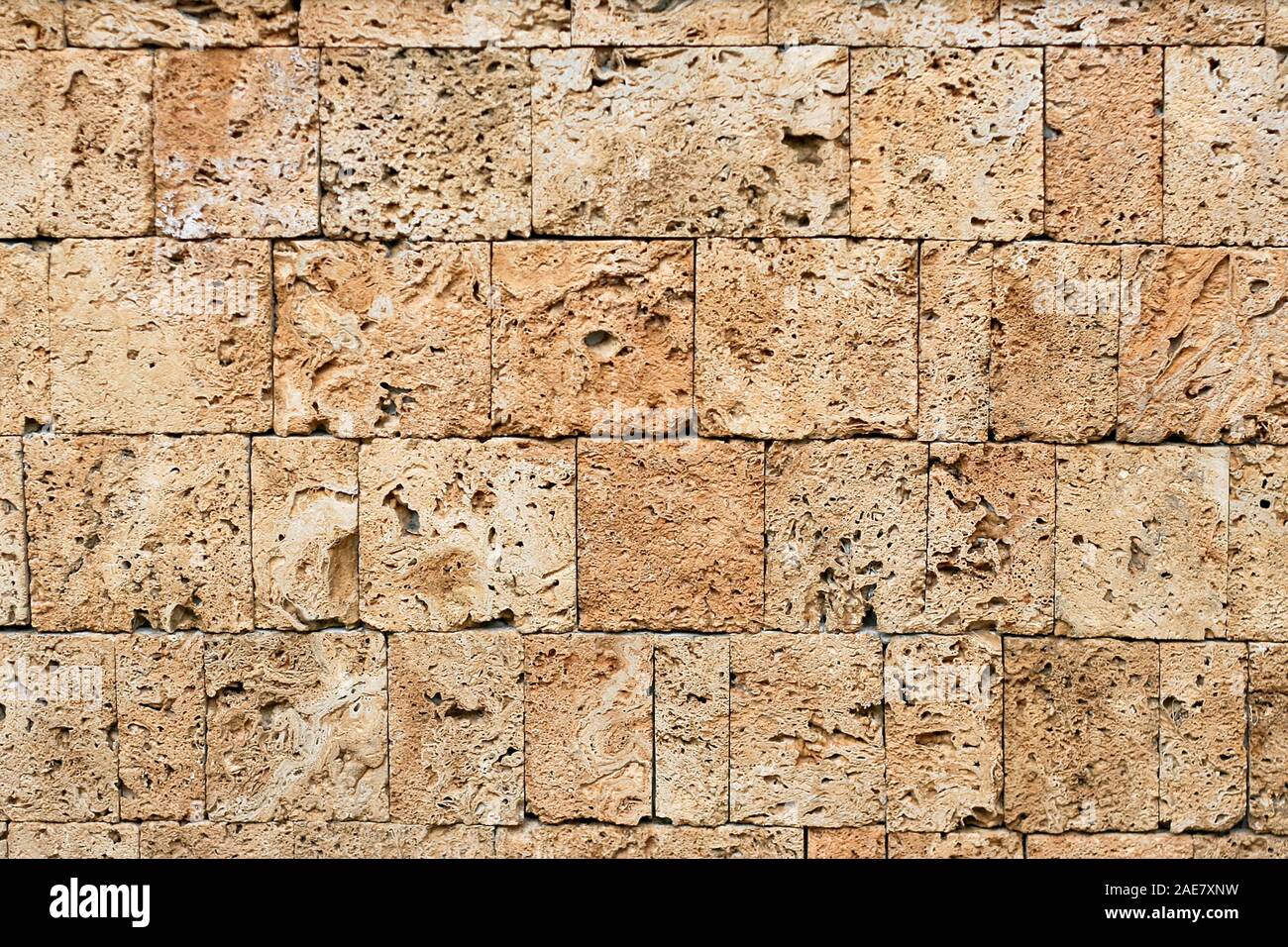 Natural look wall made from yellow stone bricks Stock Photo - Alamy
