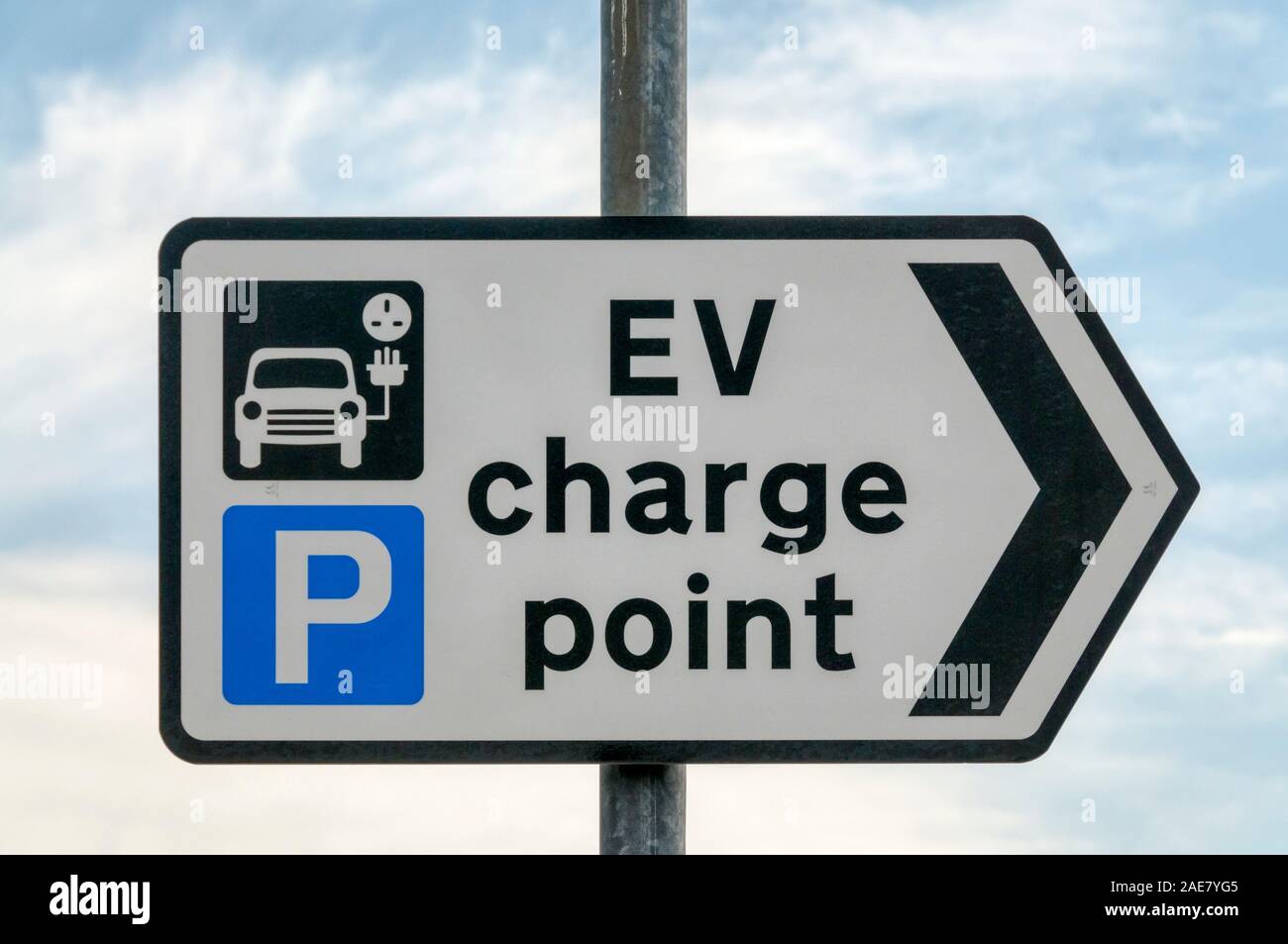 Sign to an Electric Vehicle charging point in a car park with P sign ...