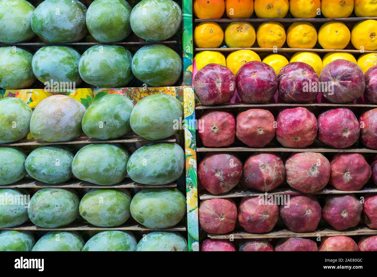 Mango, pomegranate, orange in boxes in the market Stock Photo - Alamy