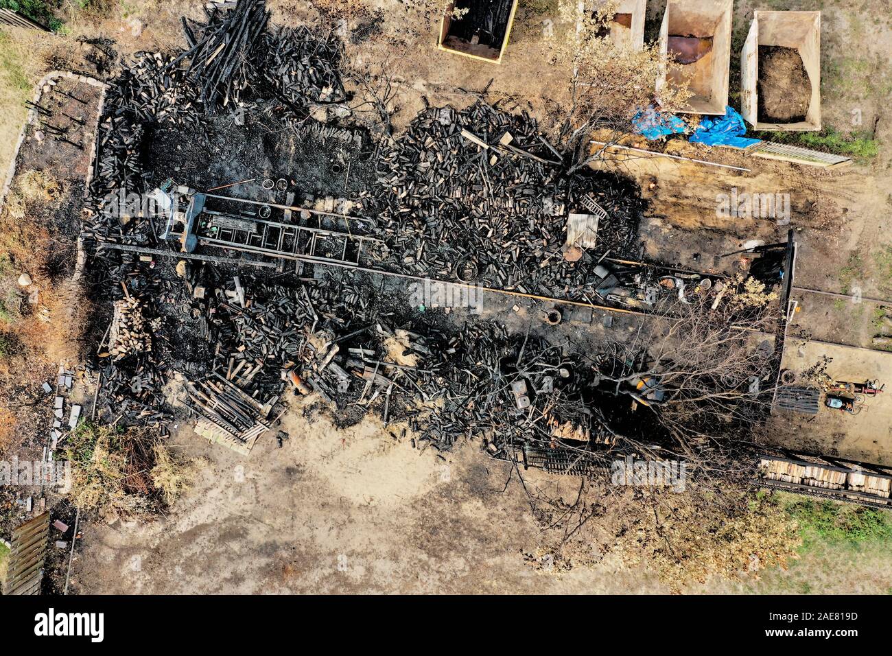 Aerial view of a wooden building completely destroyed by fire with ...