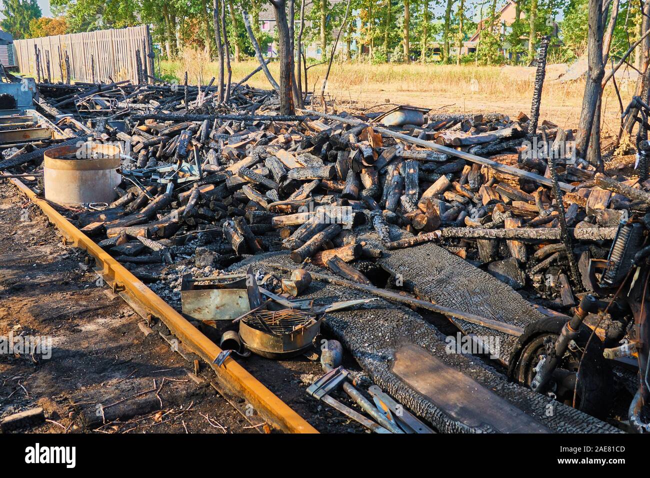 Fire ruin with fire debris from burnt wood, boards, walls and ...