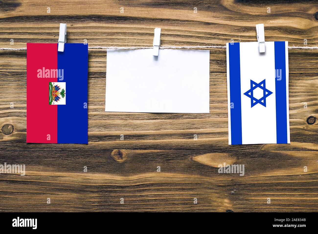 Hanging flags of Haiti and Israel attached to rope with clothes pins ...