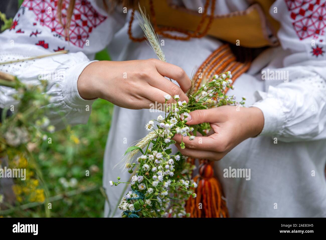Making wreaths in Belarusian traditional clothes, celebrating the pagan ...