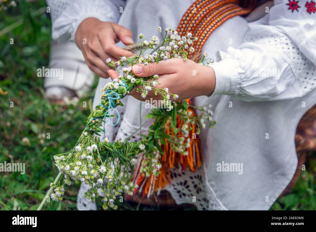 Making wreaths in Belarusian traditional clothes, celebrating the pagan ...