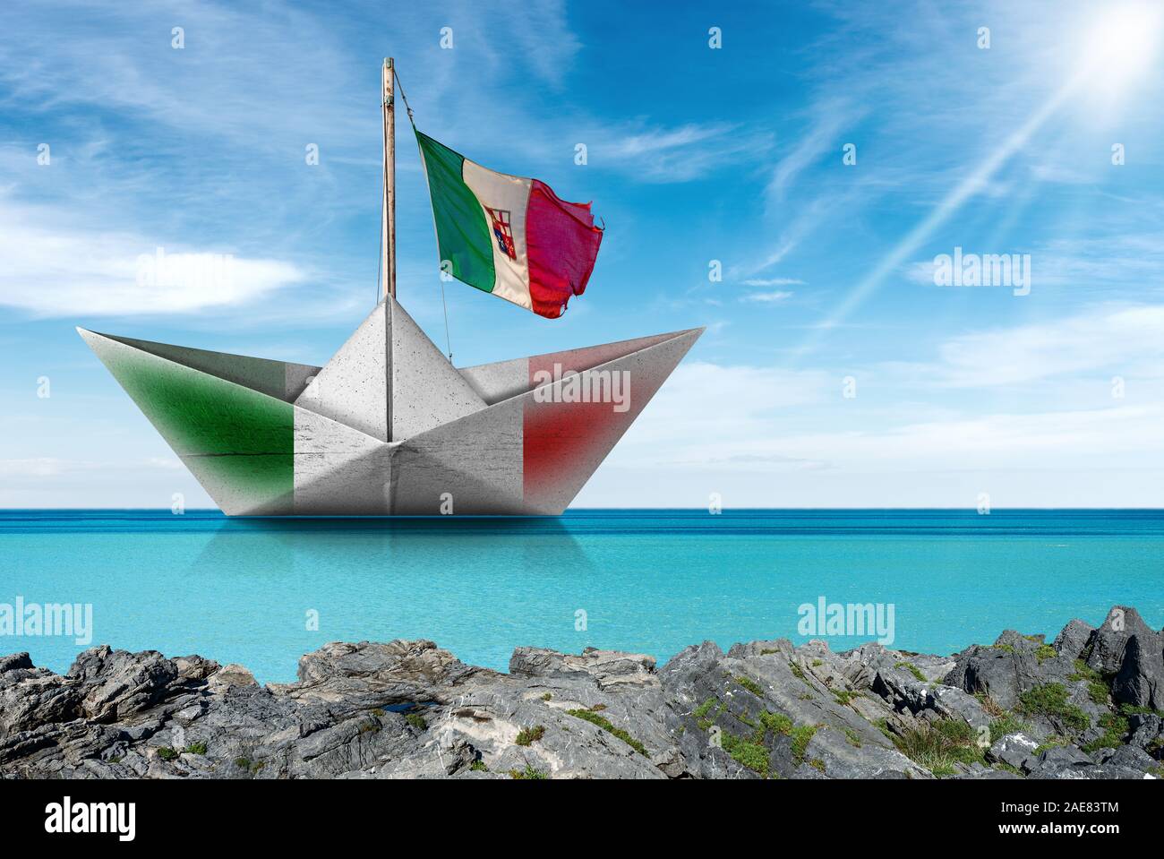 White paper boat with the Italian flag, in a turquoise sea with blue ...