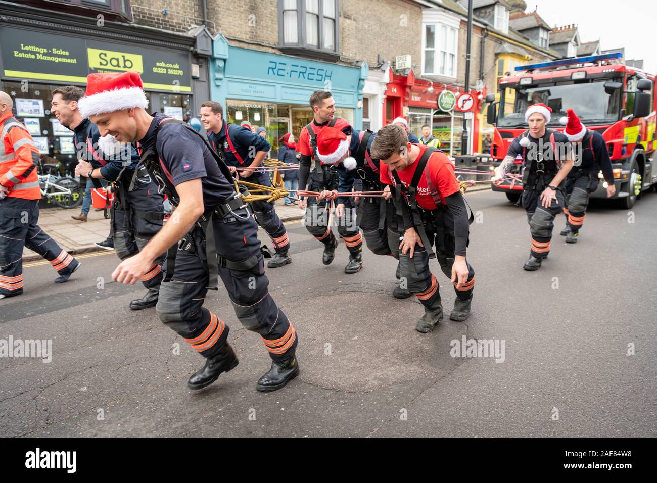 Cambridge UK December 7th 2019. Firefighters pull a fire engine as ...