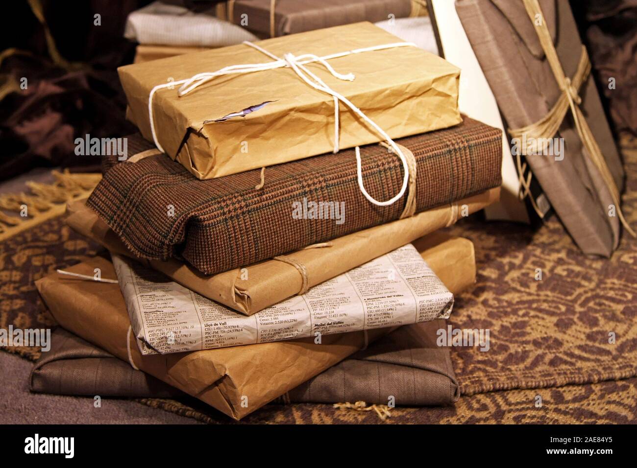 Big pile of gifts wrapped in recycled paper Stock Photo - Alamy