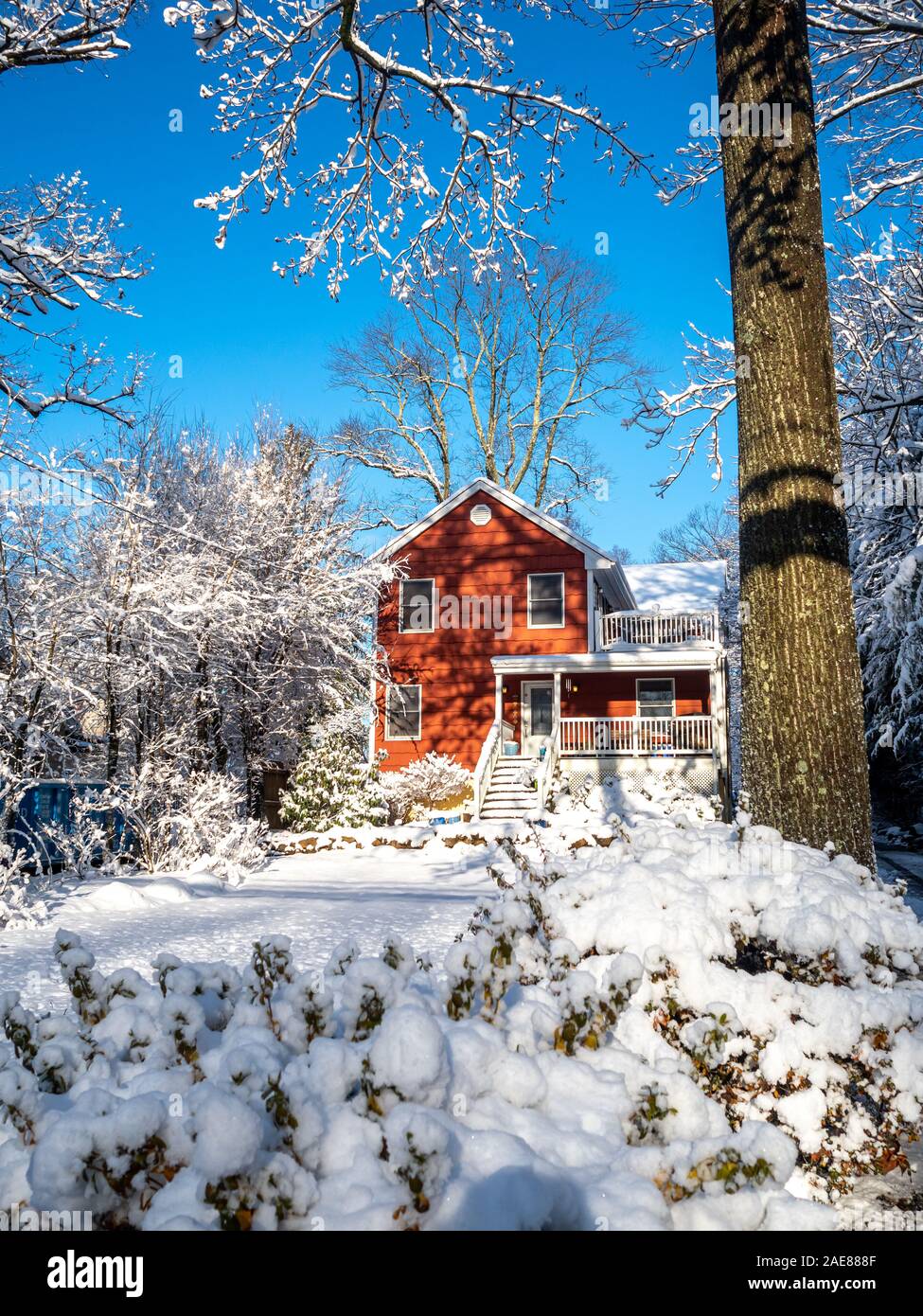 red suburban house after the first snow storm of the season in the ...