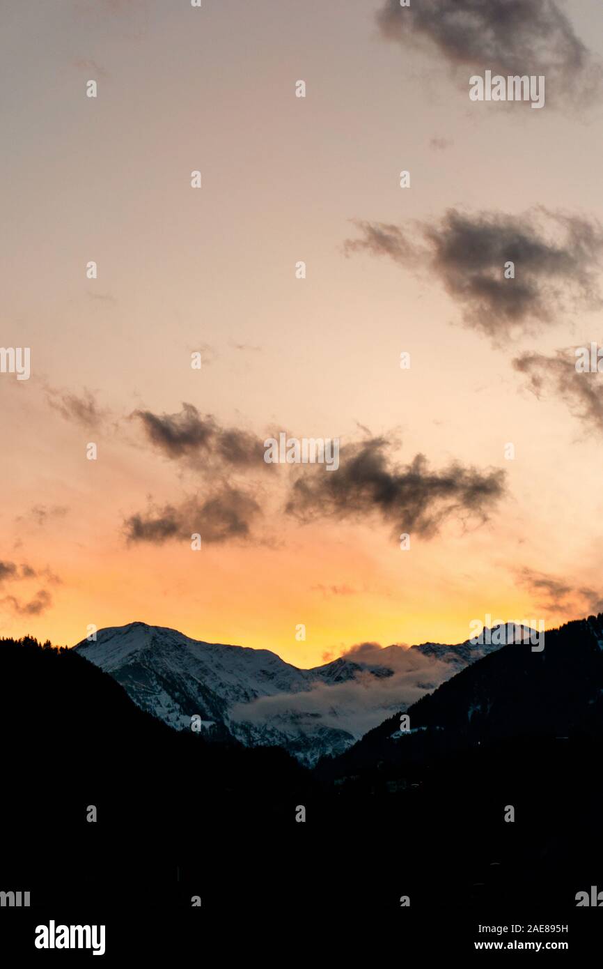 colorful winter sunset over snowy mountain landscape with dark ...