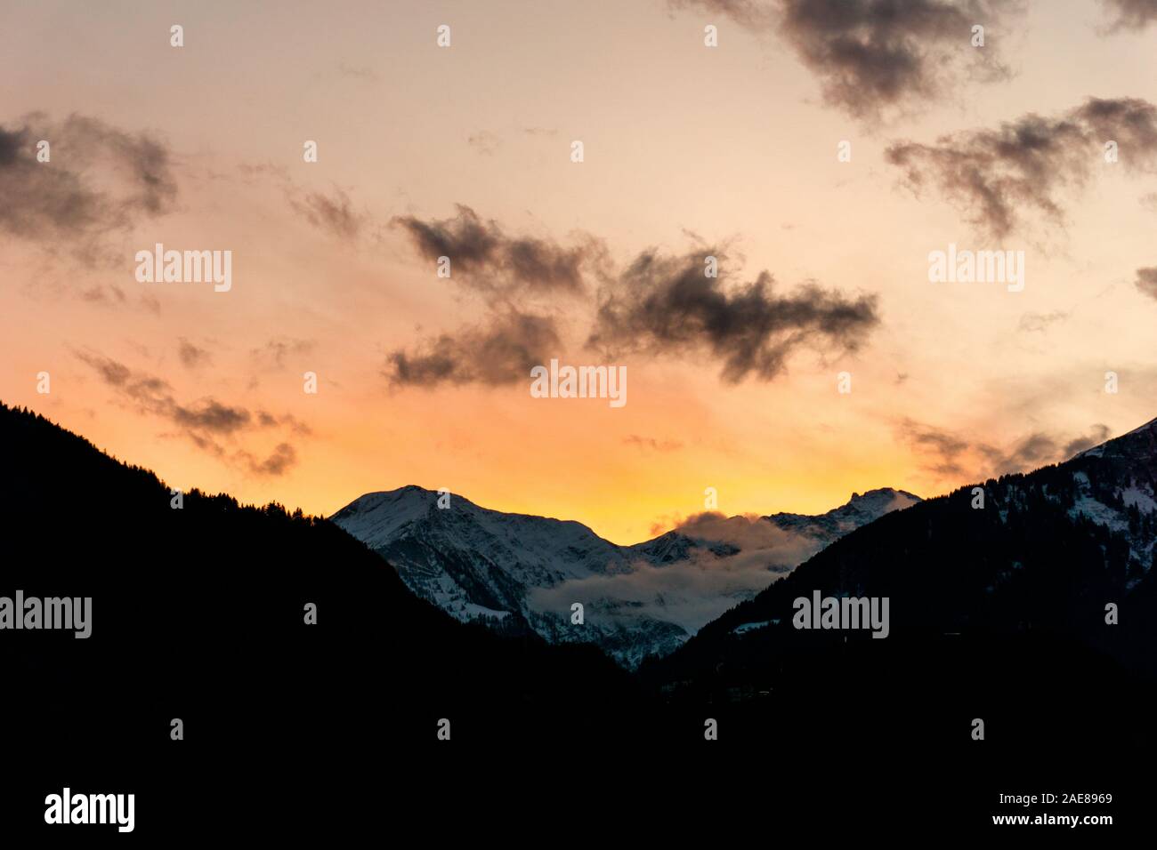 colorful winter sunset over snowy mountain landscape with dark ...