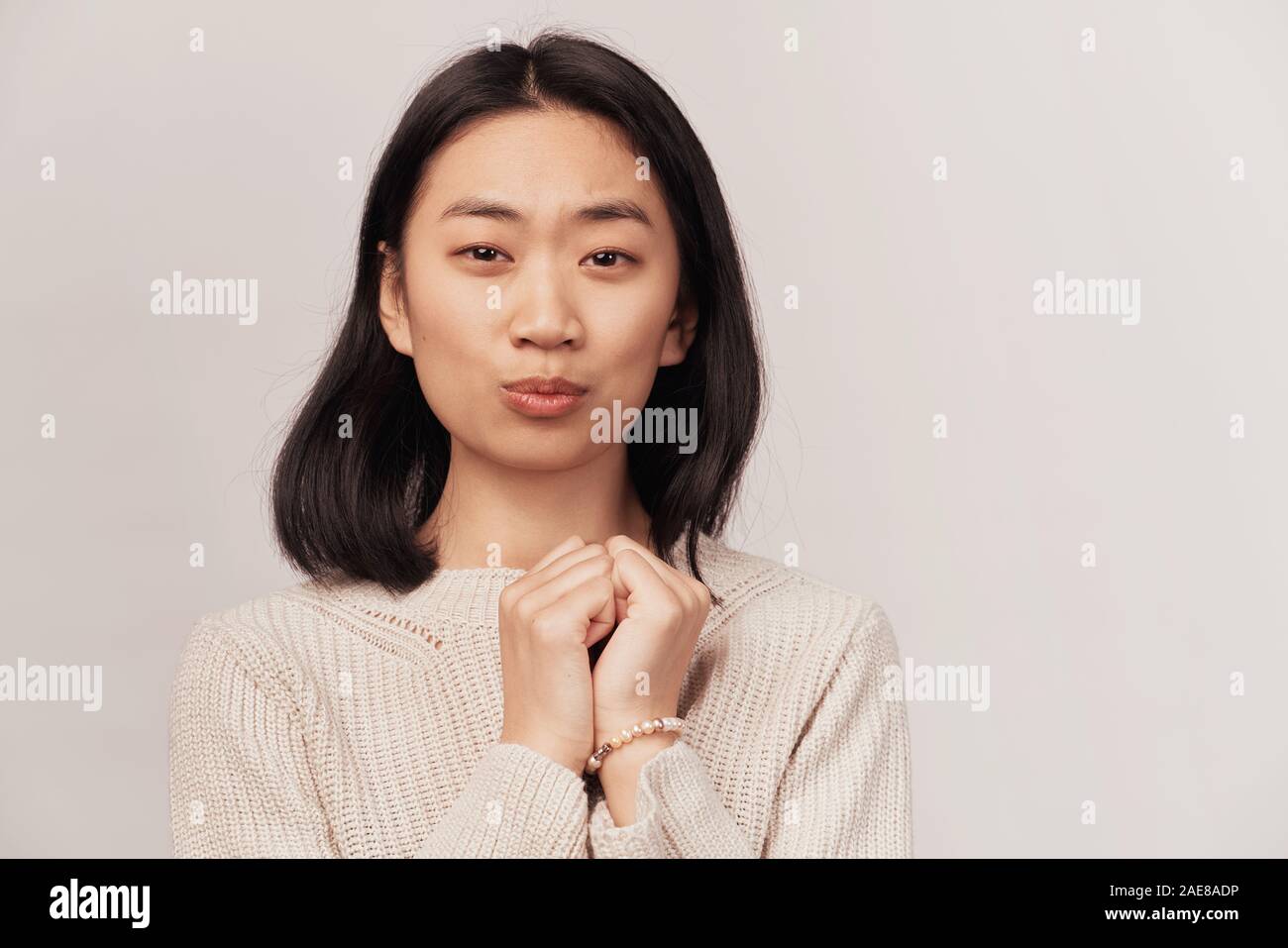 Girl has plaintive expression, frowns, pulls lips Stock Photo - Alamy