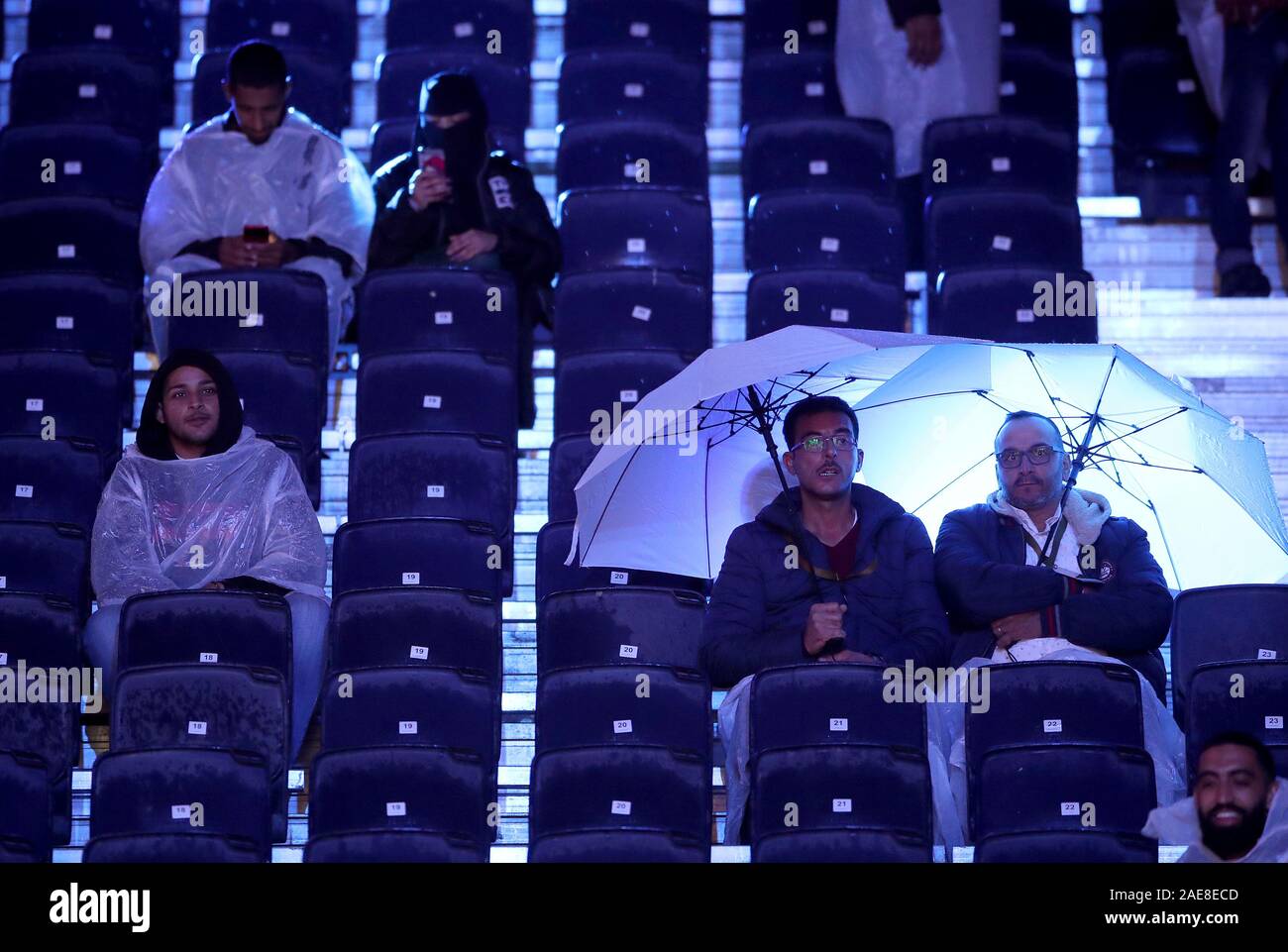 Boxing fans shelter from the rain in the stands at the Diriyah Arena ...