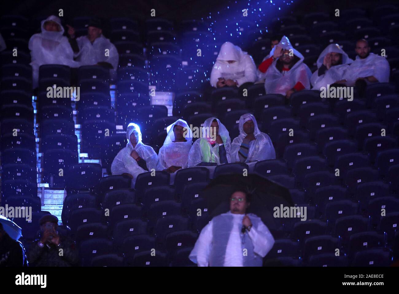 Boxing fans shelter from the rain in the stands at the Diriyah Arena ...