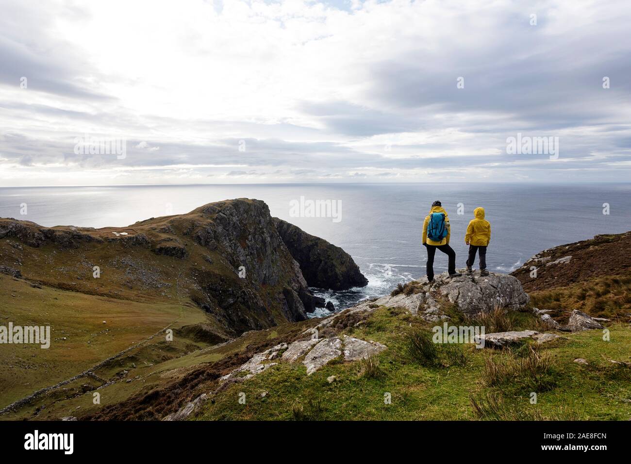 Mother and son standing on rocks at the Slieve League cliffs from ...