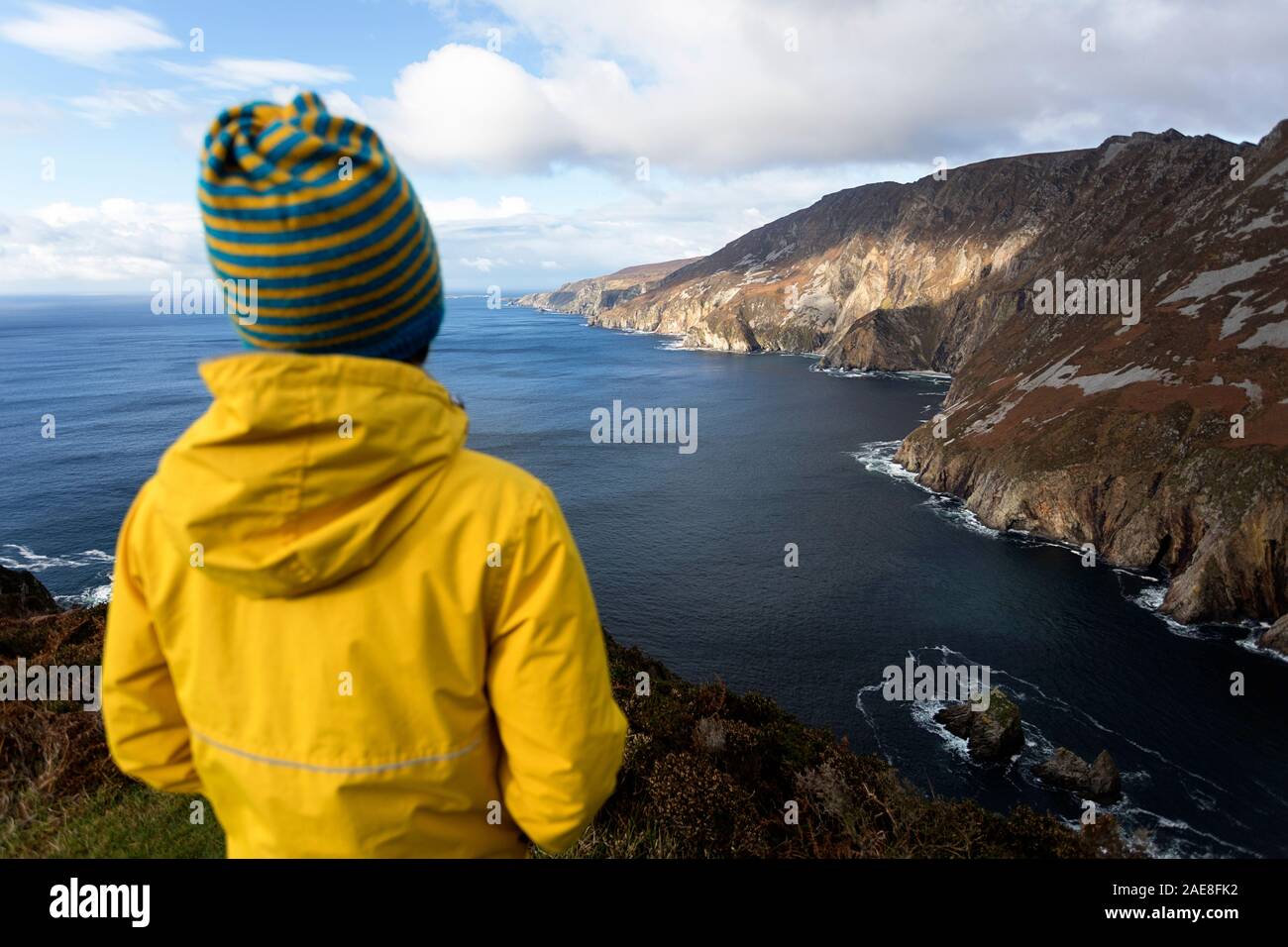 young boy looking at the ocean at the Slieve League cliffs from ...